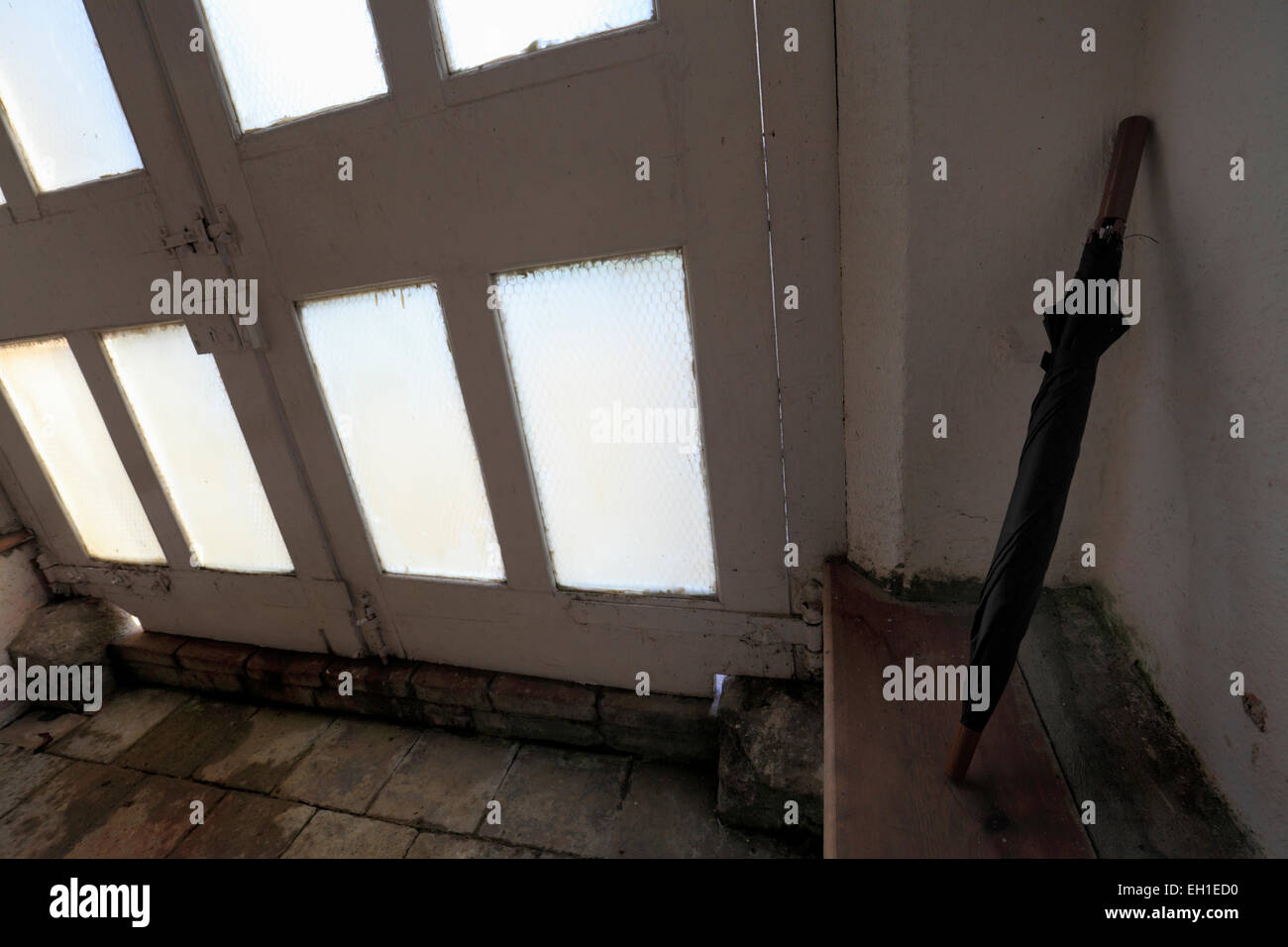 An umbrella left inside a church porch Stock Photo - Alamy