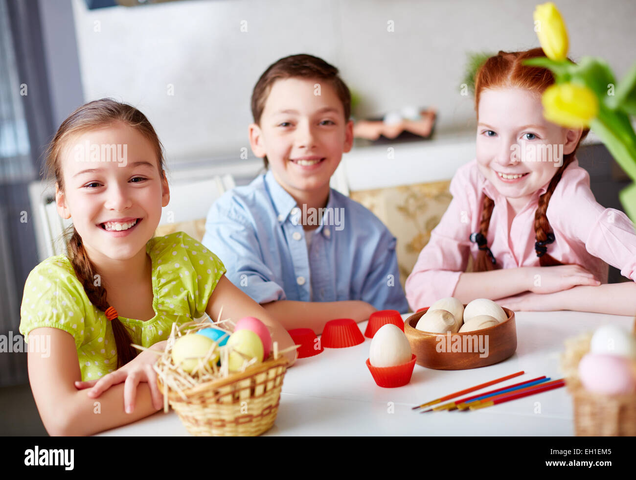 Group of children sitting at table with eggs Stock Photo - Alamy