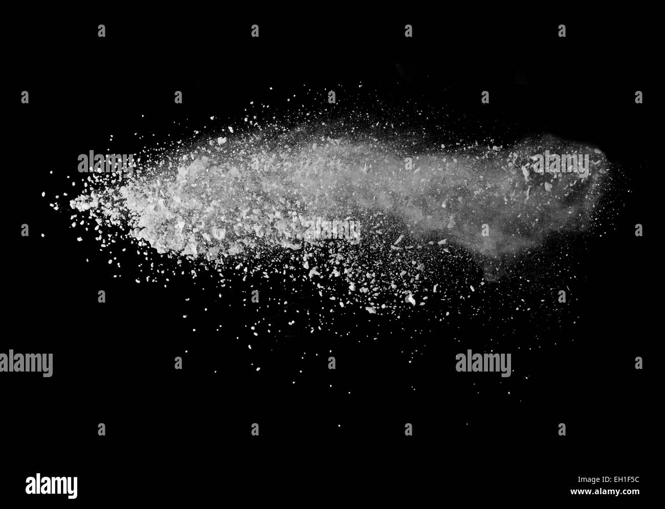 Freeze motion of white dust explosion isolated on black background ...