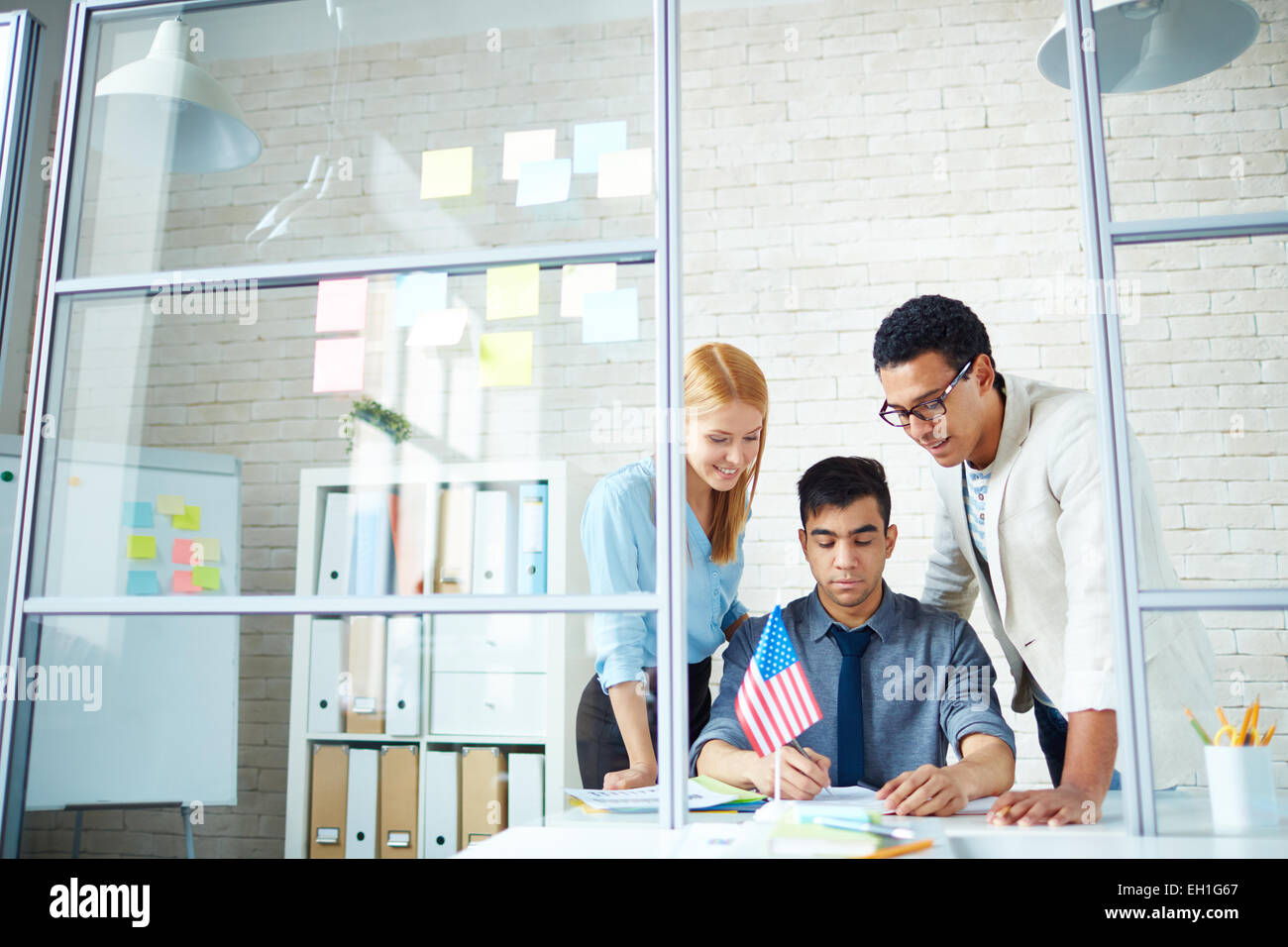 Group of employees reading document at meeting Stock Photo - Alamy