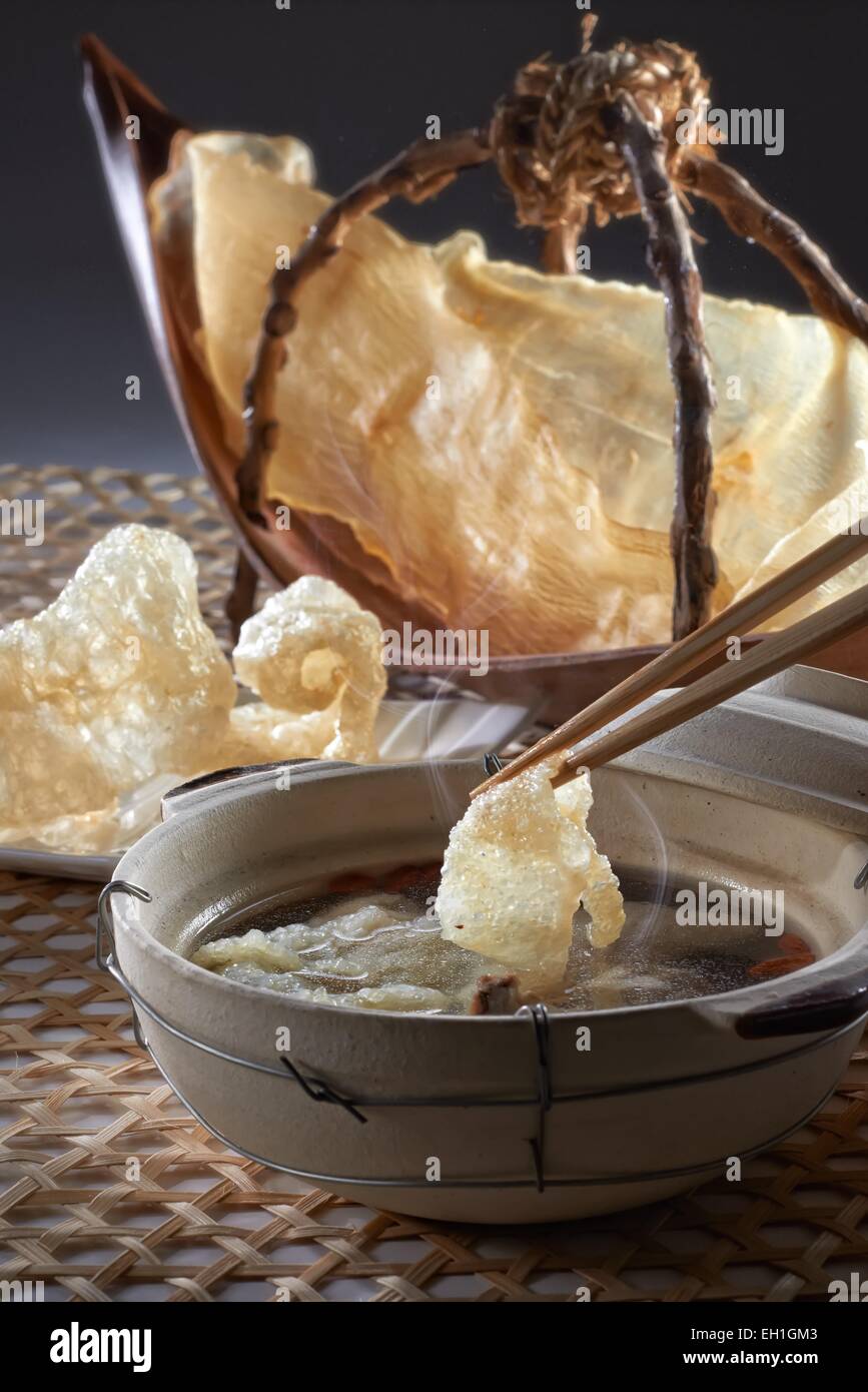 Fish maw soup table set with clay pot and raw material Stock Photo - Alamy