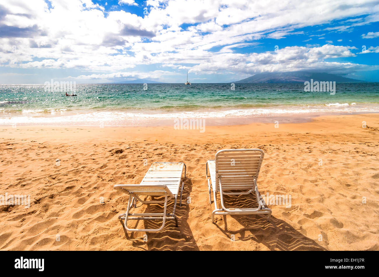 day view of Makena Beach with empty deckchairs, famous tourist ...
