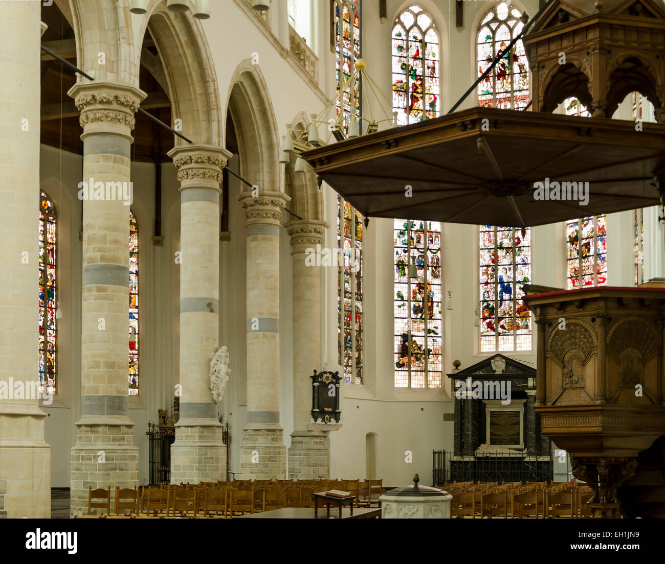 Interior of the 'Oude Kerk' of Delft with great coloumns, stained glass ...