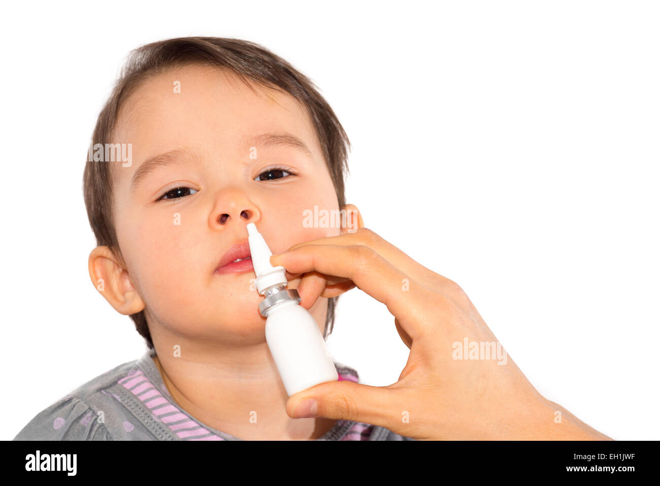 Parent's hand of a sick little girl applies a nasal spray Stock Photo ...
