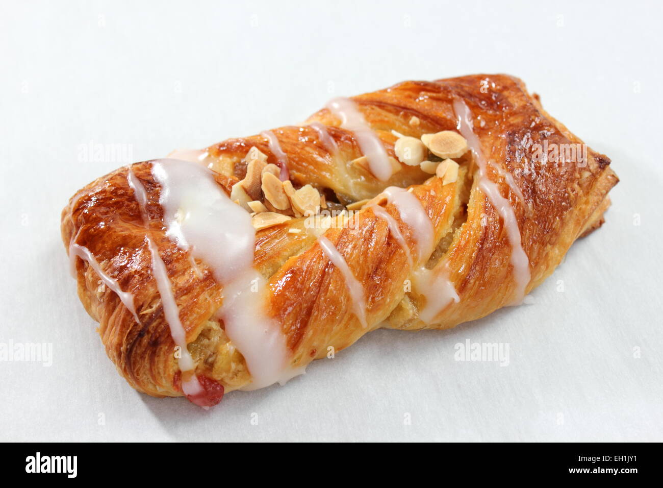Danish pastry twist on white dish Stock Photo - Alamy