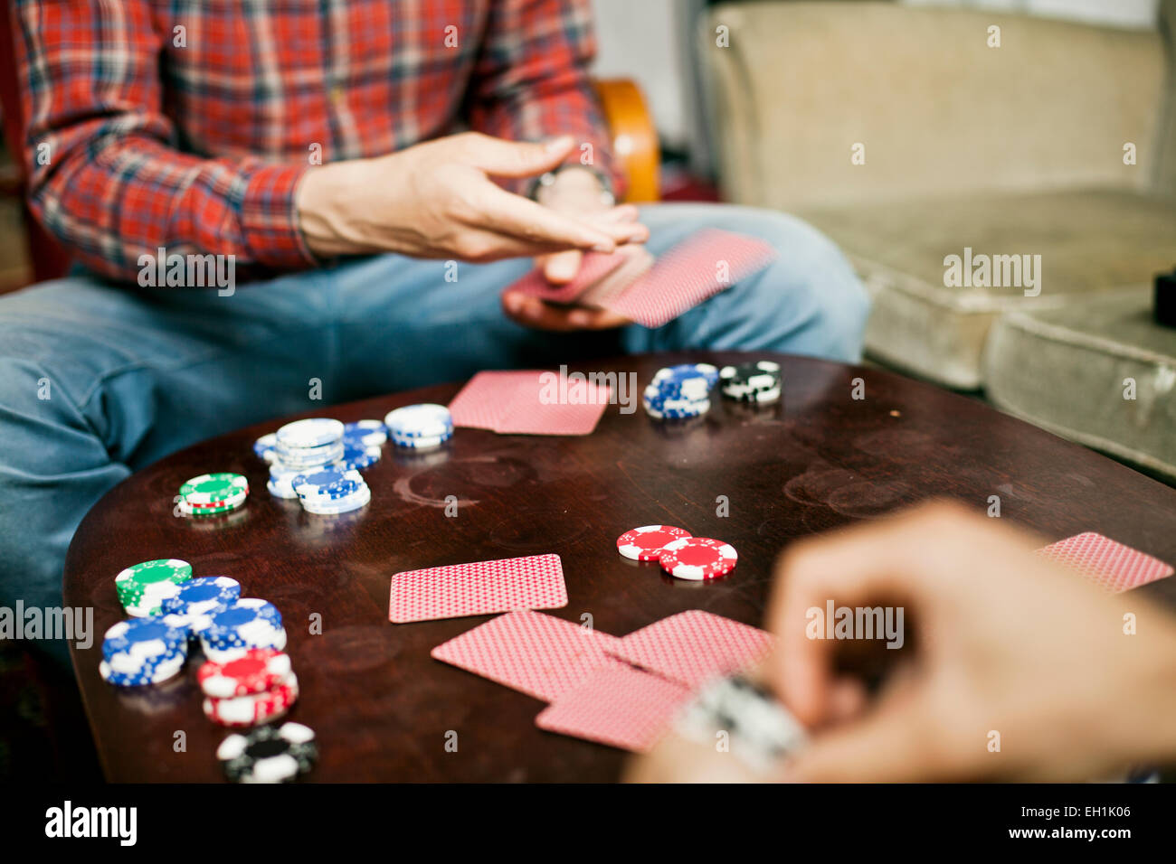 Cropped hands holding playing cards hi-res stock photography and images ...