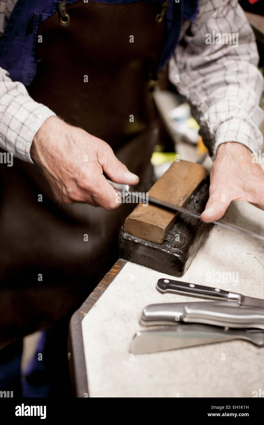 Man sharpening knives hi-res stock photography and images - Alamy