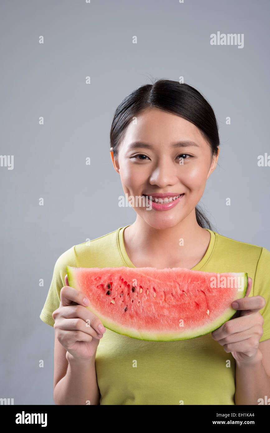 Young woman eating watermelon Stock Photo - Alamy