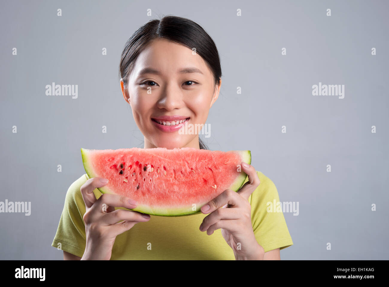 Young woman eating watermelon Stock Photo - Alamy
