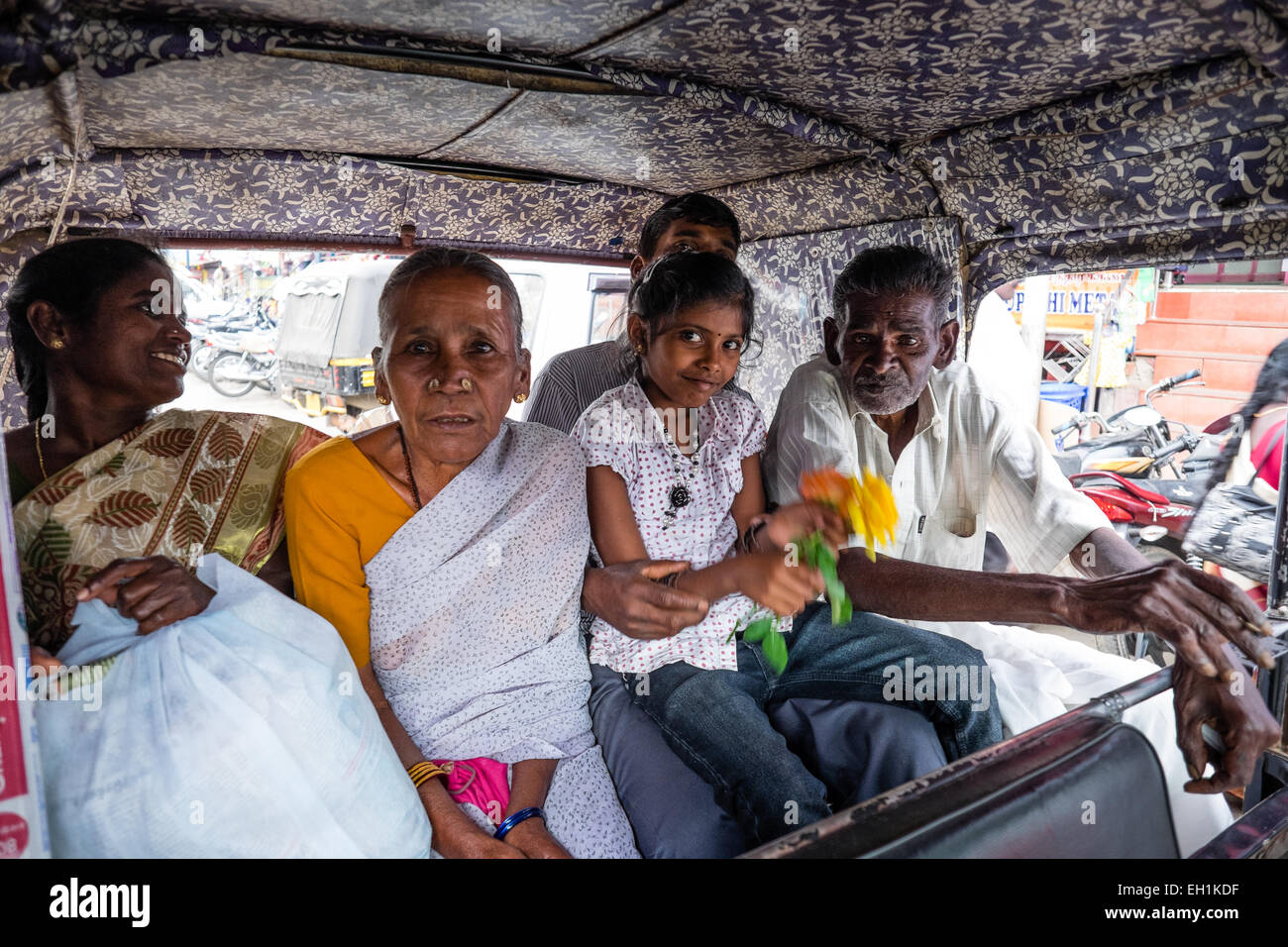 A family of 5 squash into a tuk tuk rickshaw for a journey in India ...
