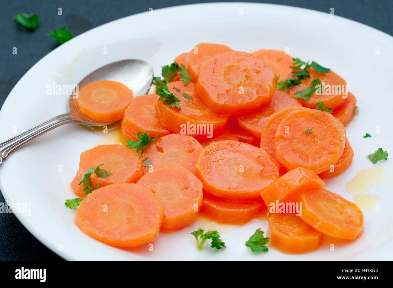 Glazed carrot coins with fresh parsley Stock Photo - Alamy