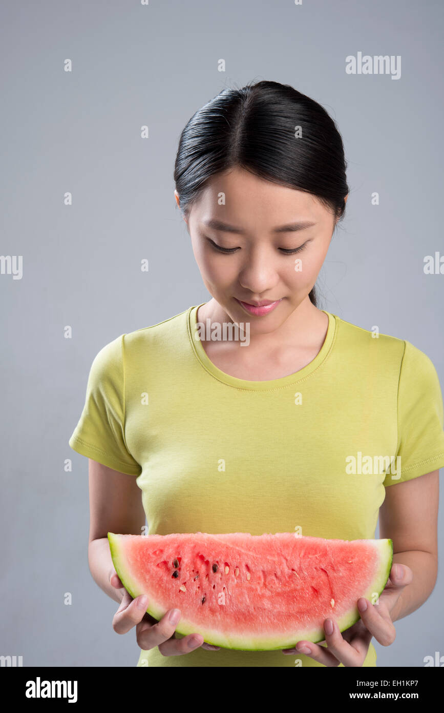 Young woman eating watermelon Stock Photo - Alamy