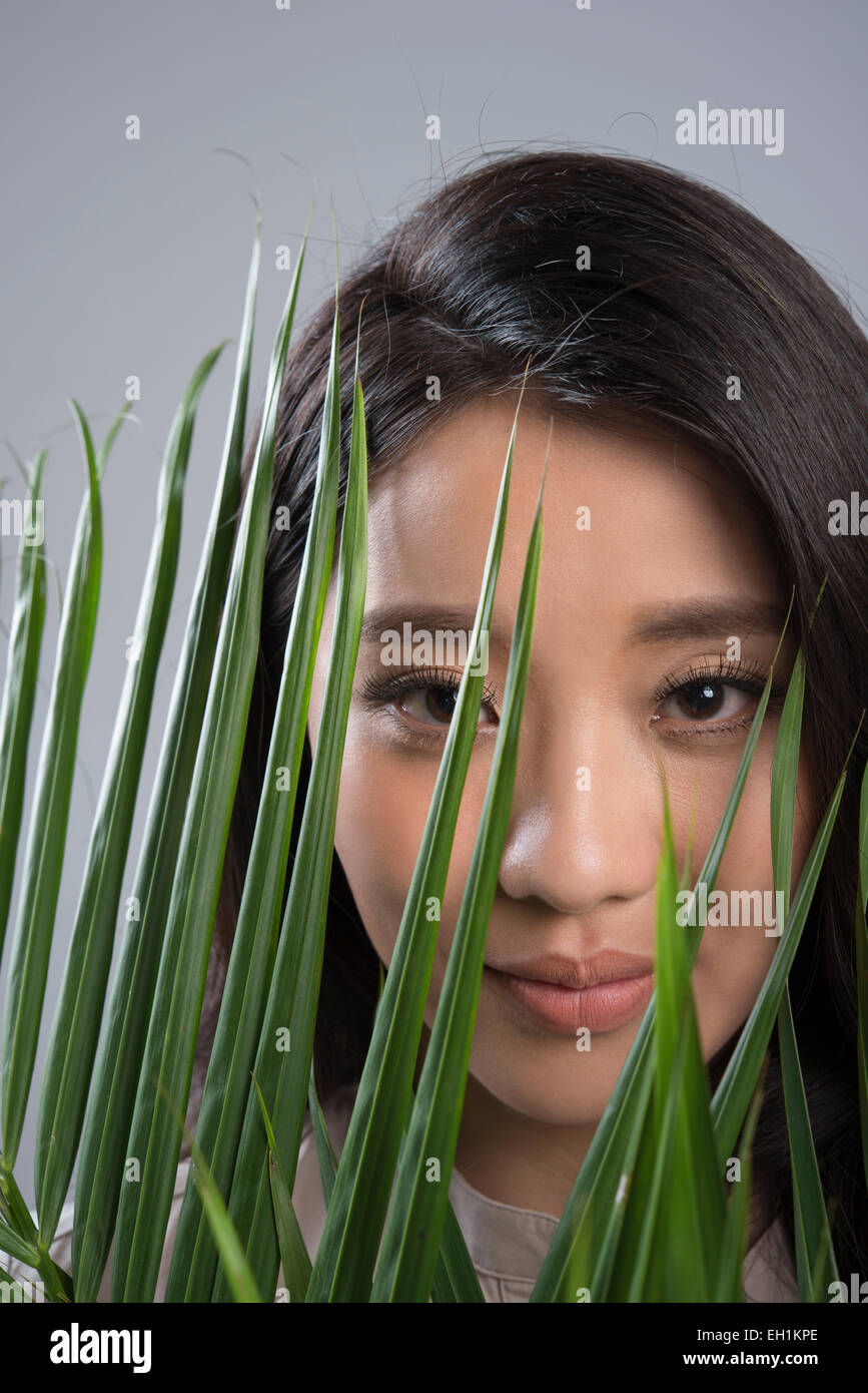 Young woman under palm tree Stock Photo - Alamy
