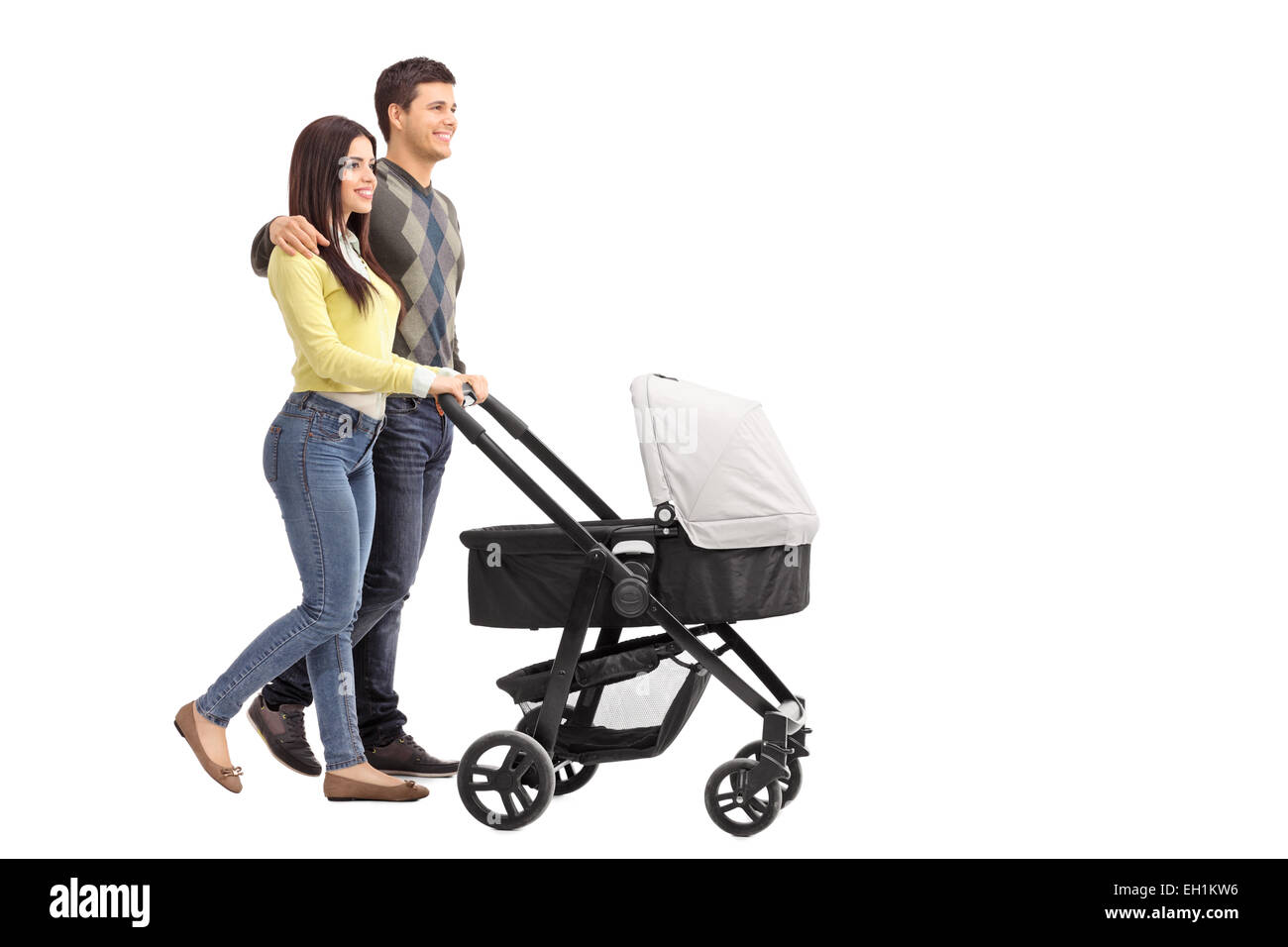 Full length portrait of a young parents pushing a baby stroller ...