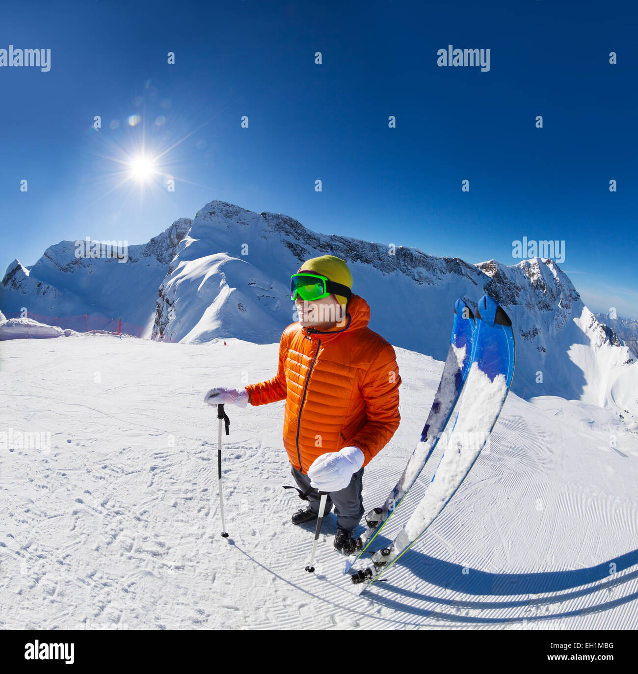 Guy with ski near in snow during sunny winter day Stock Photo - Alamy