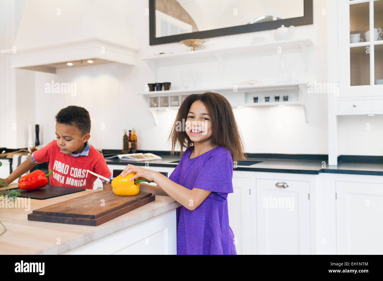 Brother and sister cooking in kitchen Stock Photo - Alamy
