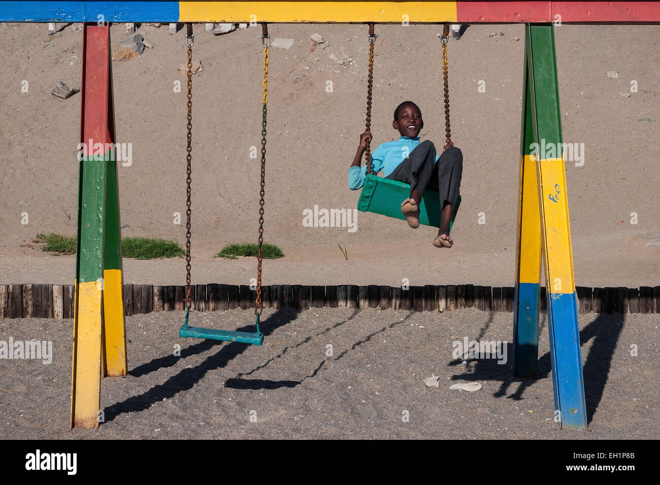 Local boy playing on a swing, Lüderitz, Namibia Stock Photo - Alamy