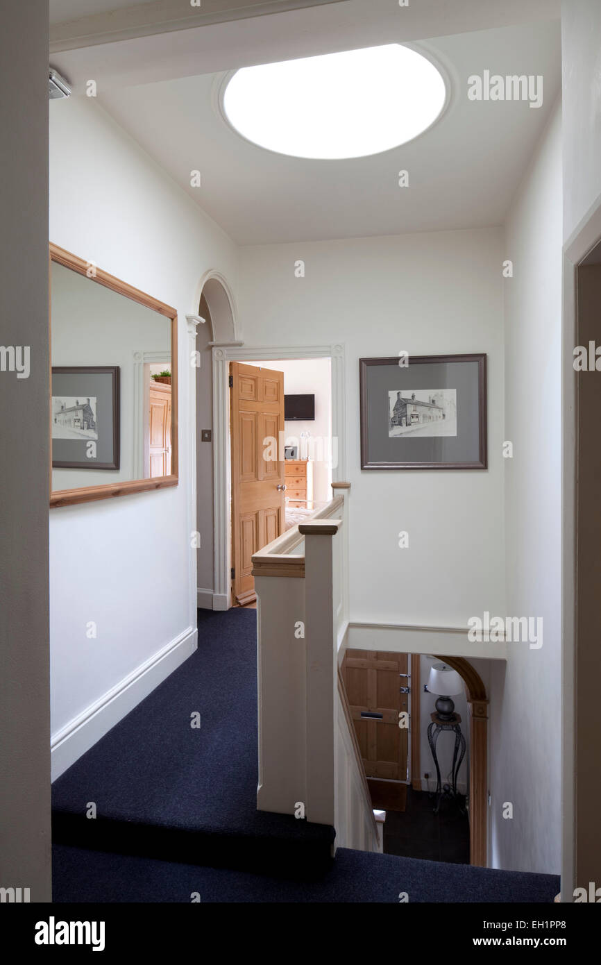 Circular lightwell in blue landing corridor of Macclesfield townhouse ...