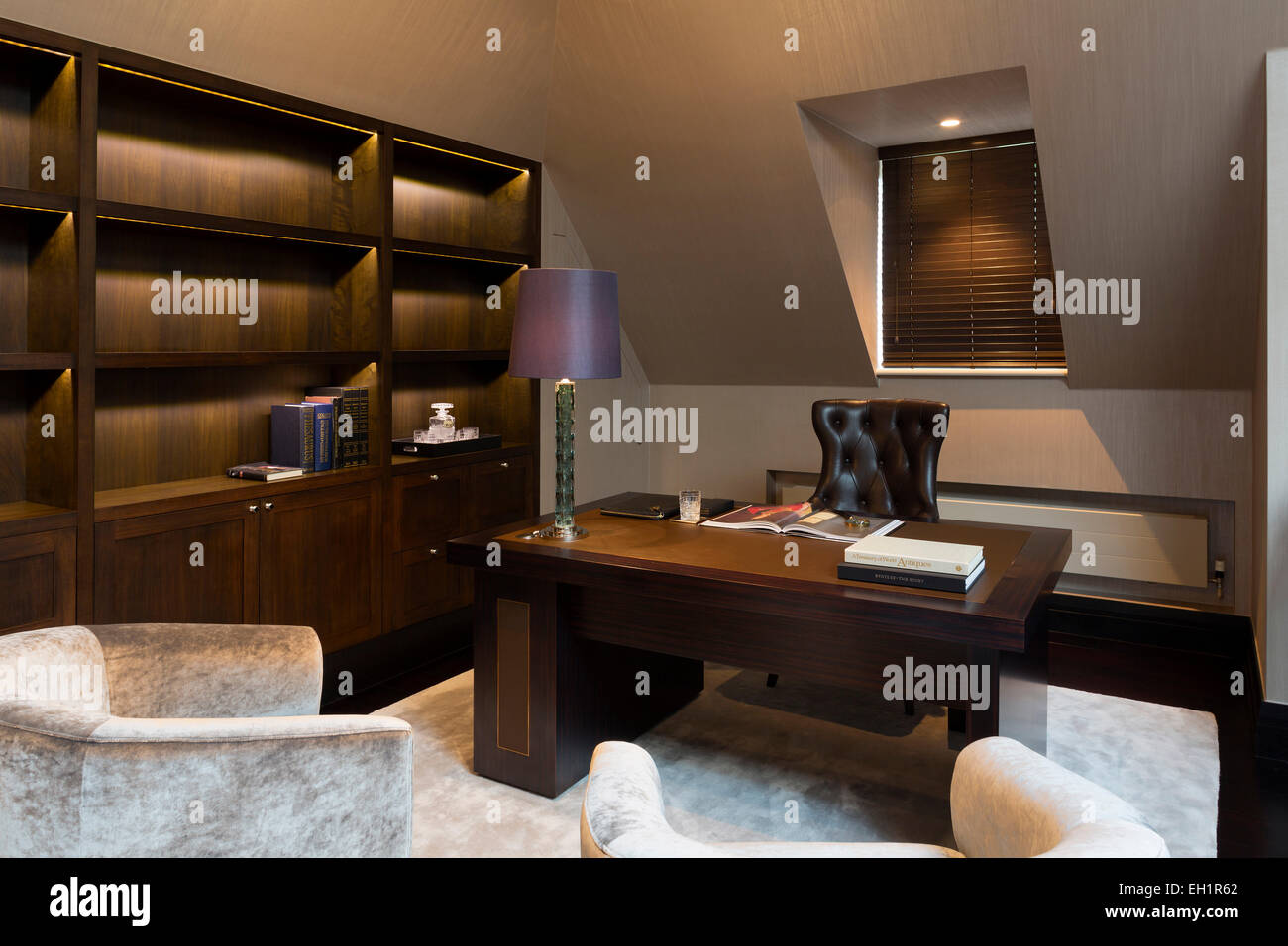 Study / office area with custom made shelves and wooden desk. Luxurious ...