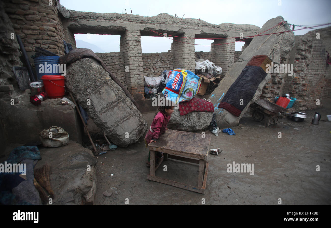 Kabul, Afghanistan. 5th Mar, 2015. An Afghan child stands outside his ...