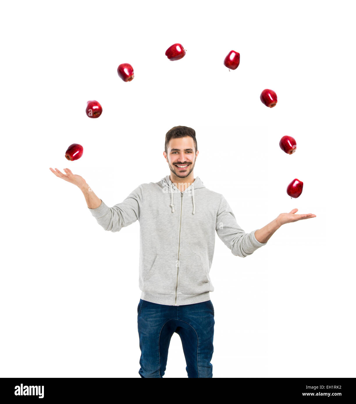 Happy young man juggling with apples on a white background Stock Photo ...
