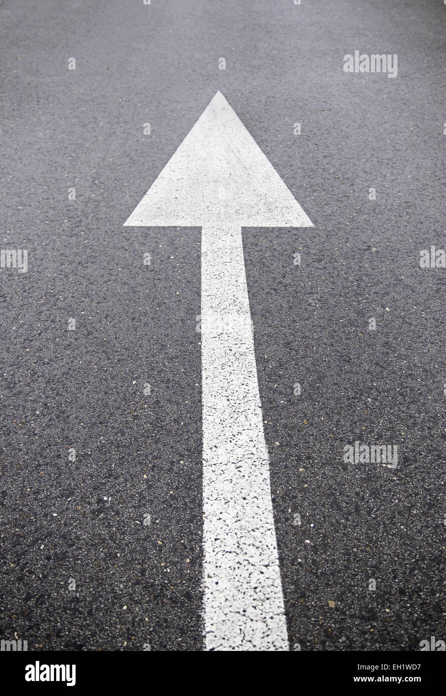 Arrow direction on asphalt, detail of a direction sign, road safety ...
