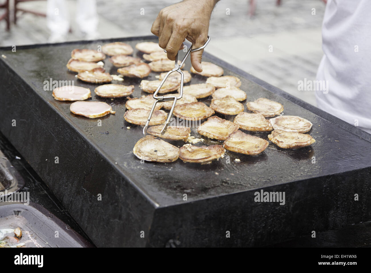 Detail of person cooking meat hi-res stock photography and images - Alamy