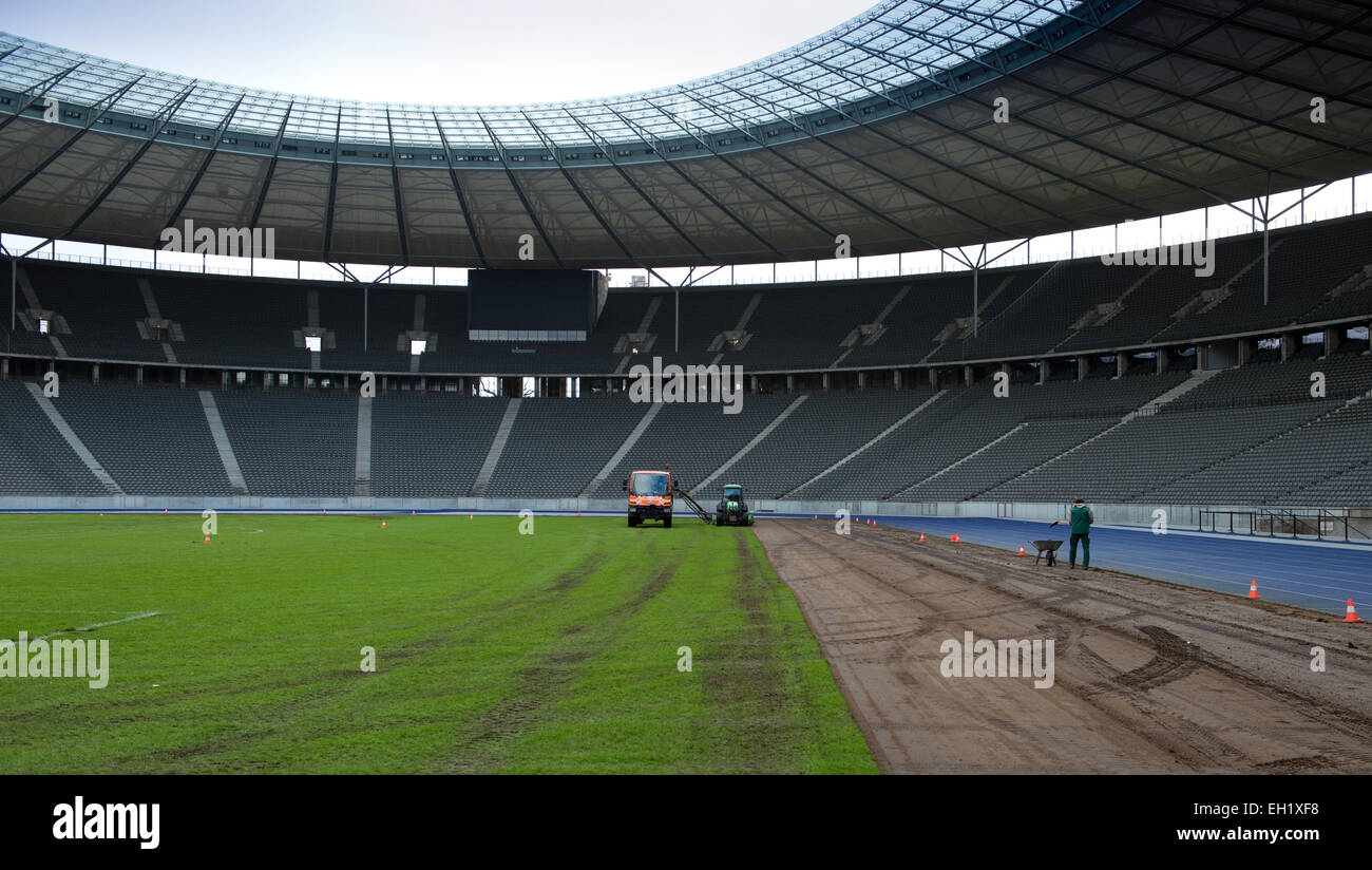 Playing field maintenance workers remove turf from the Olympic Stadium ...