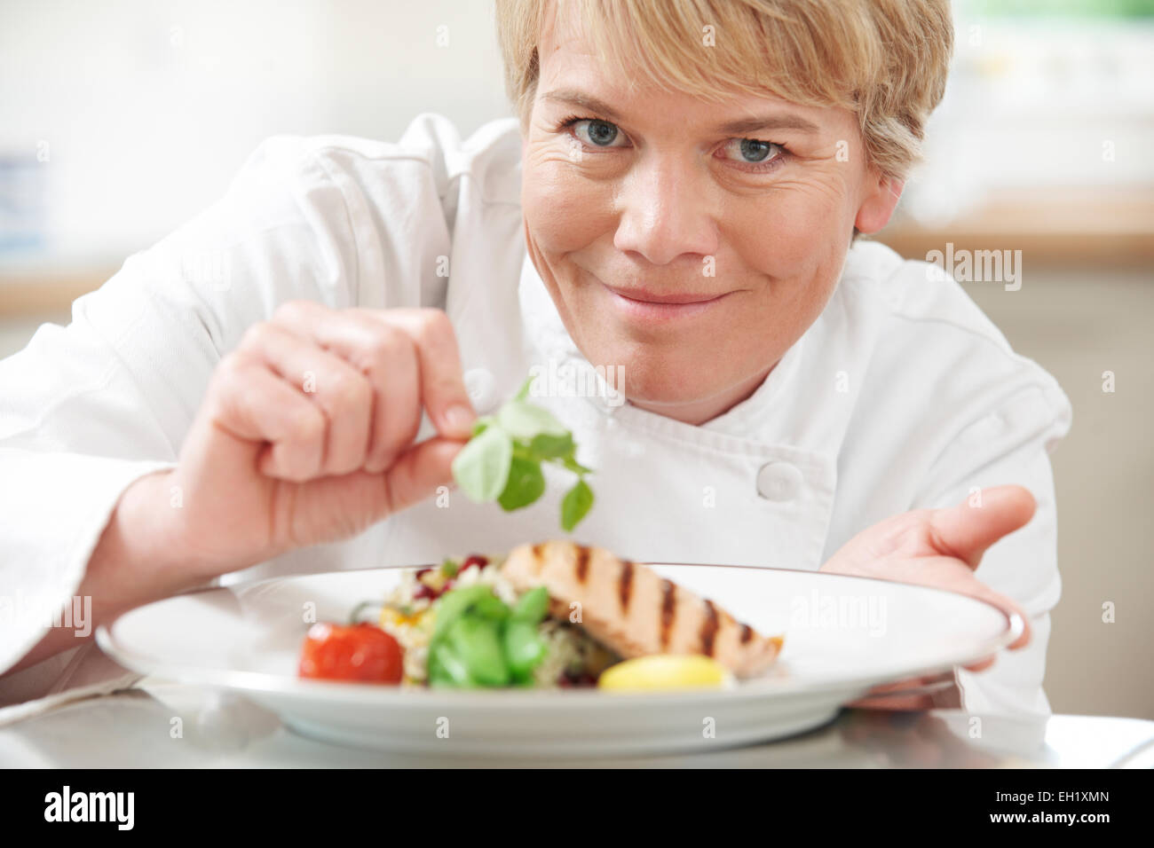 Chef Adding Garnish To Meal In Restaurant Kitchen Stock Photo - Alamy