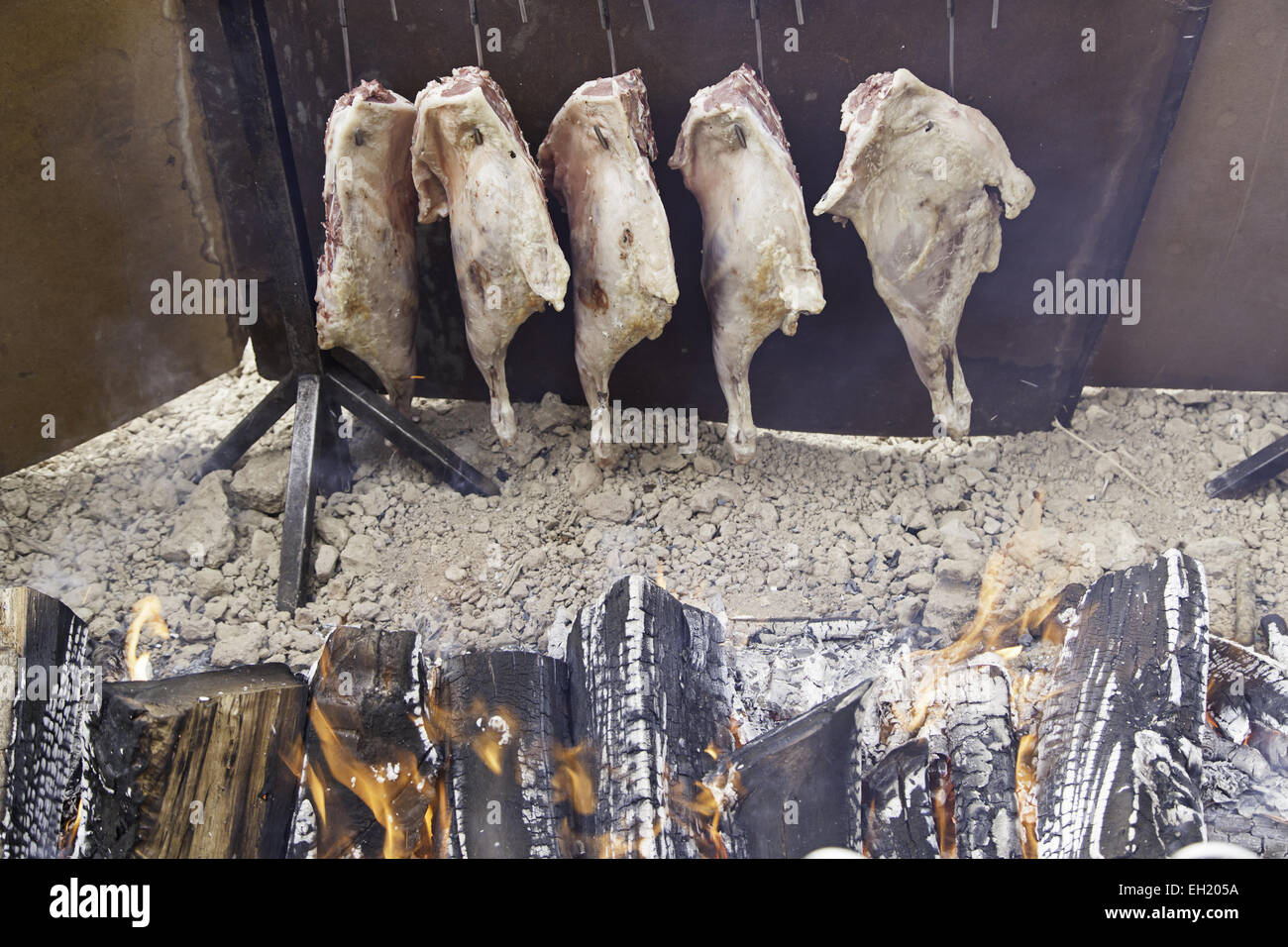 Fire Roasted Lamb detail how to cook meat with fire Stock Photo - Alamy