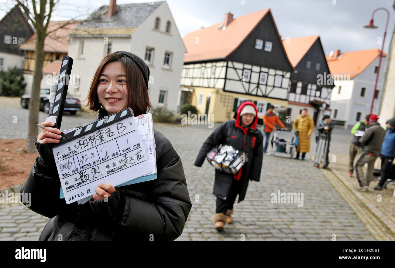 Production assistant Yang Rui takes the slate during the filming of a ...