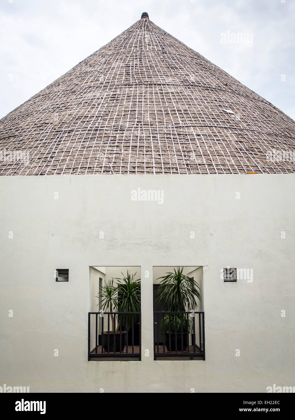 Close-up of white wall with cone-shaped roof Stock Photo - Alamy