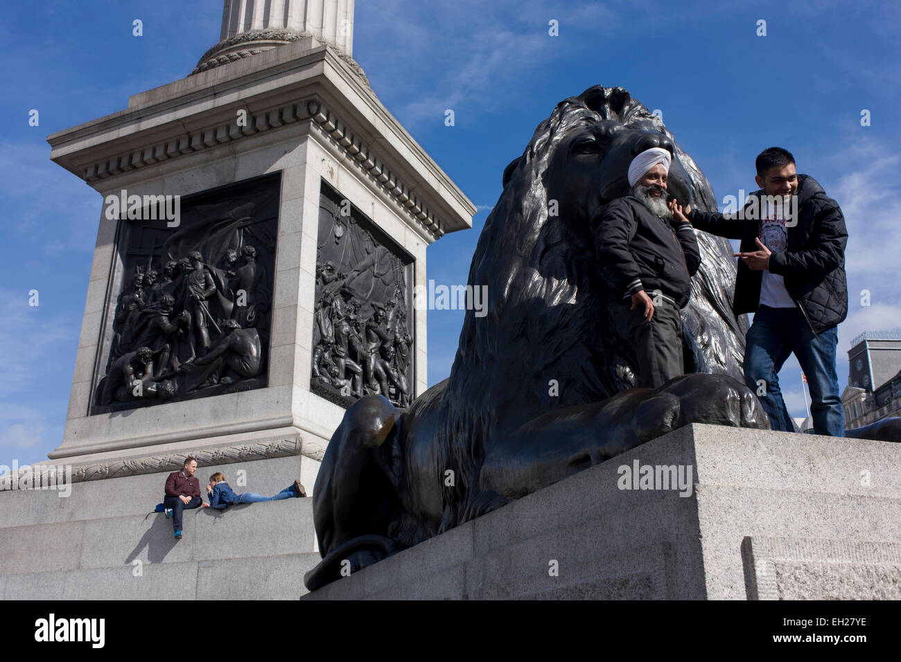 A Sikh man with another, beneath one of the four lions at the base of ...
