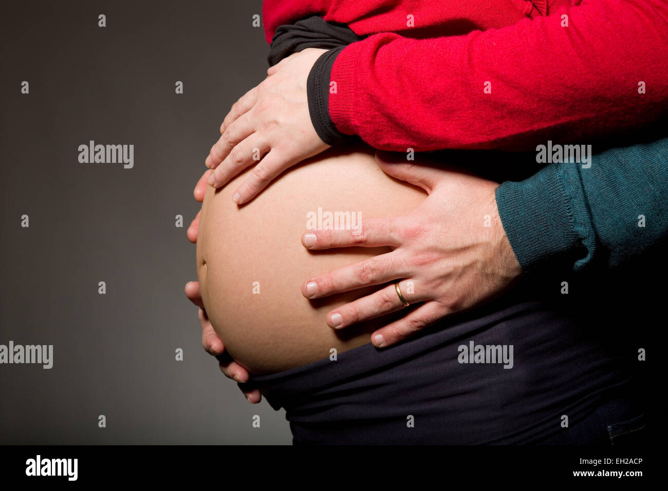 Hands hug belly hi-res stock photography and images - Alamy
