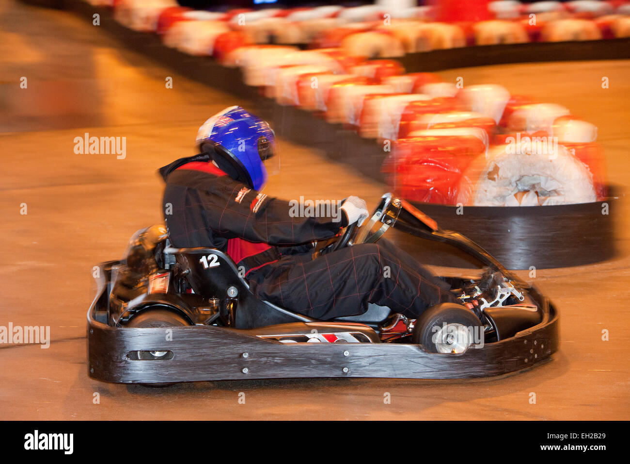 A group of teanagers visit an indoor go-cart track Stock Photo - Alamy