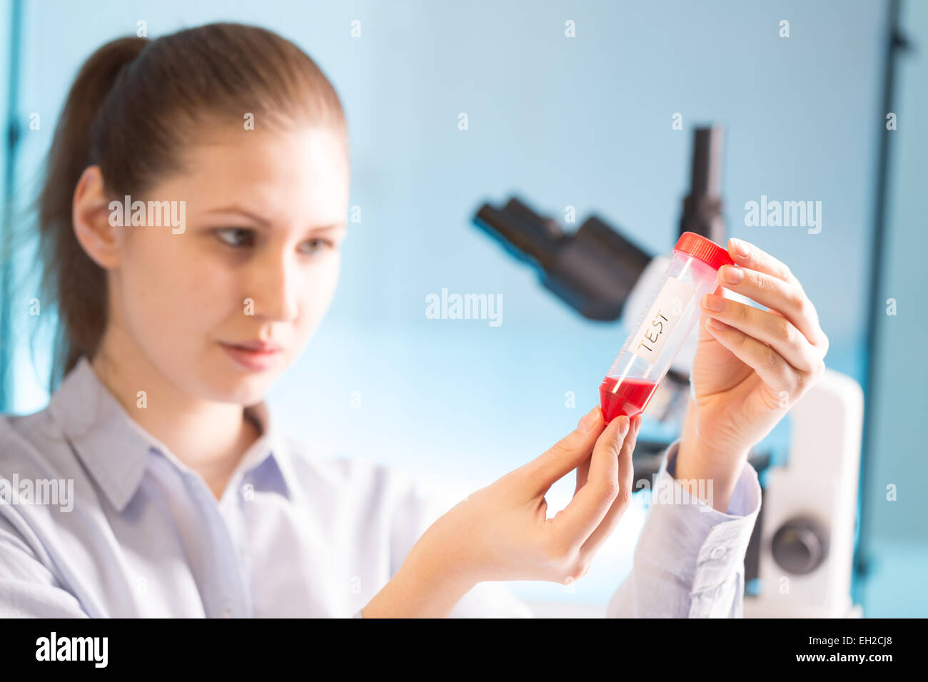 Young student woman medical / scientific researcher / doctor looking at ...