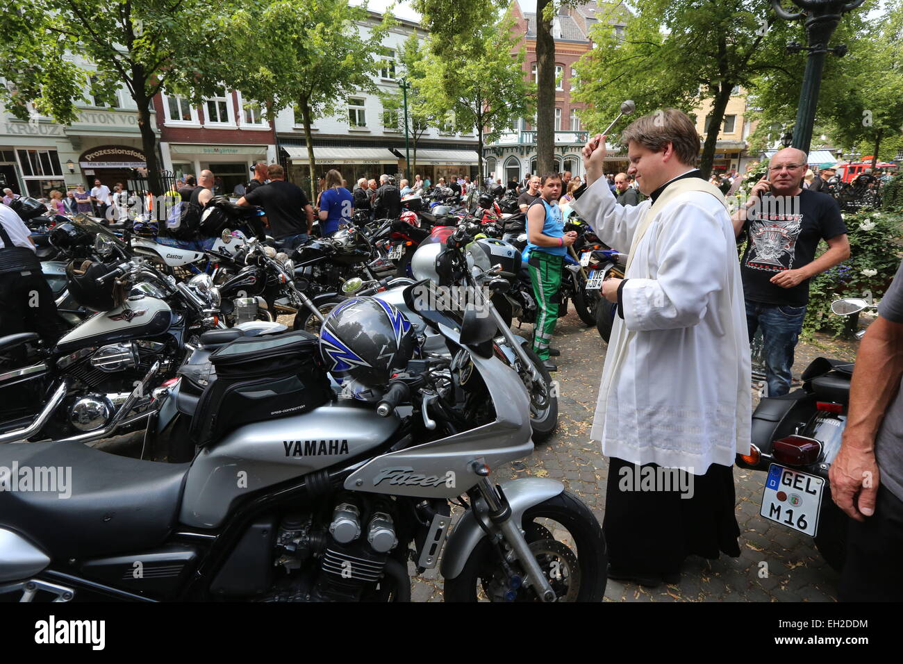 A priest blesses motorcycles and their riders during a motorcycle ...