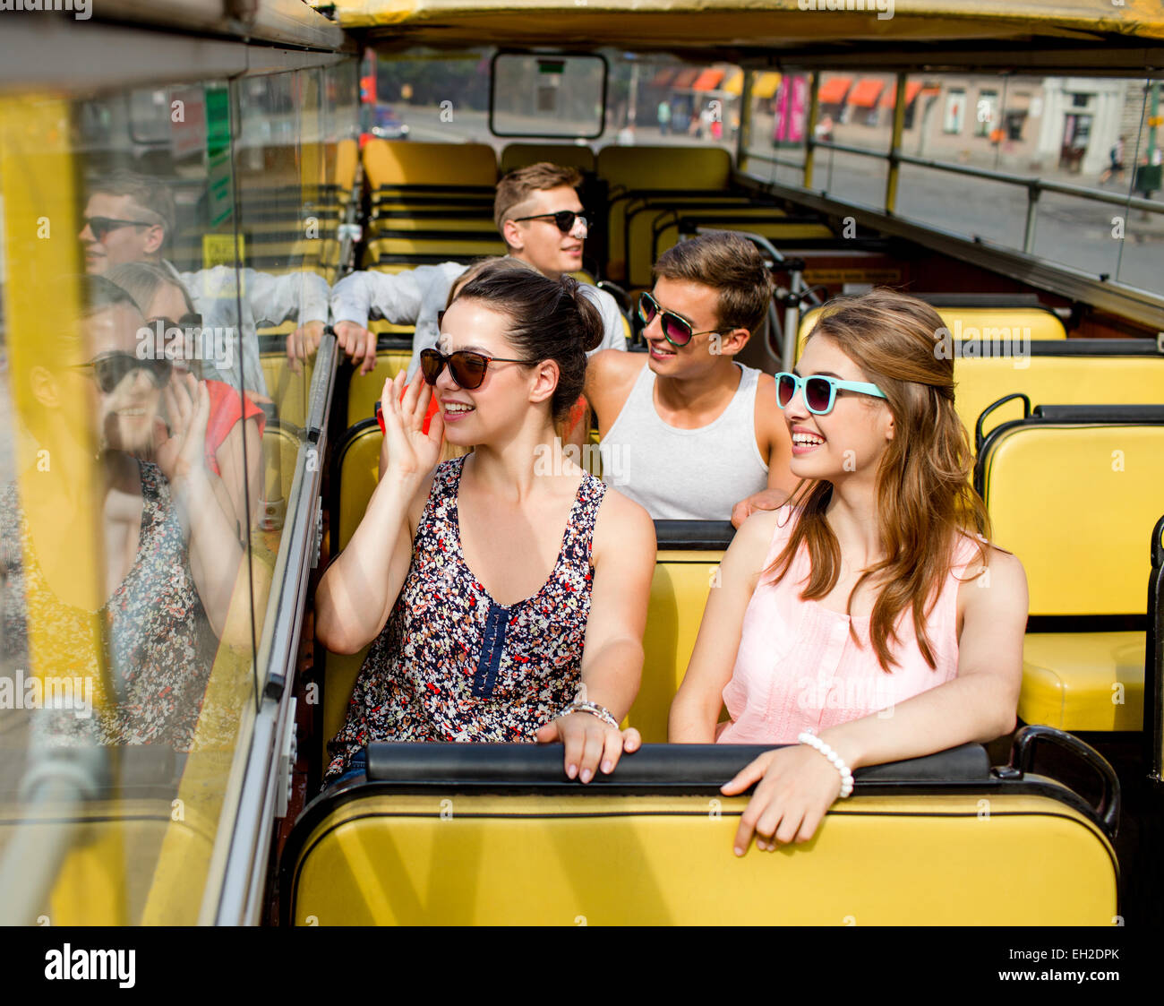 group of smiling friends traveling by tour bus Stock Photo - Alamy