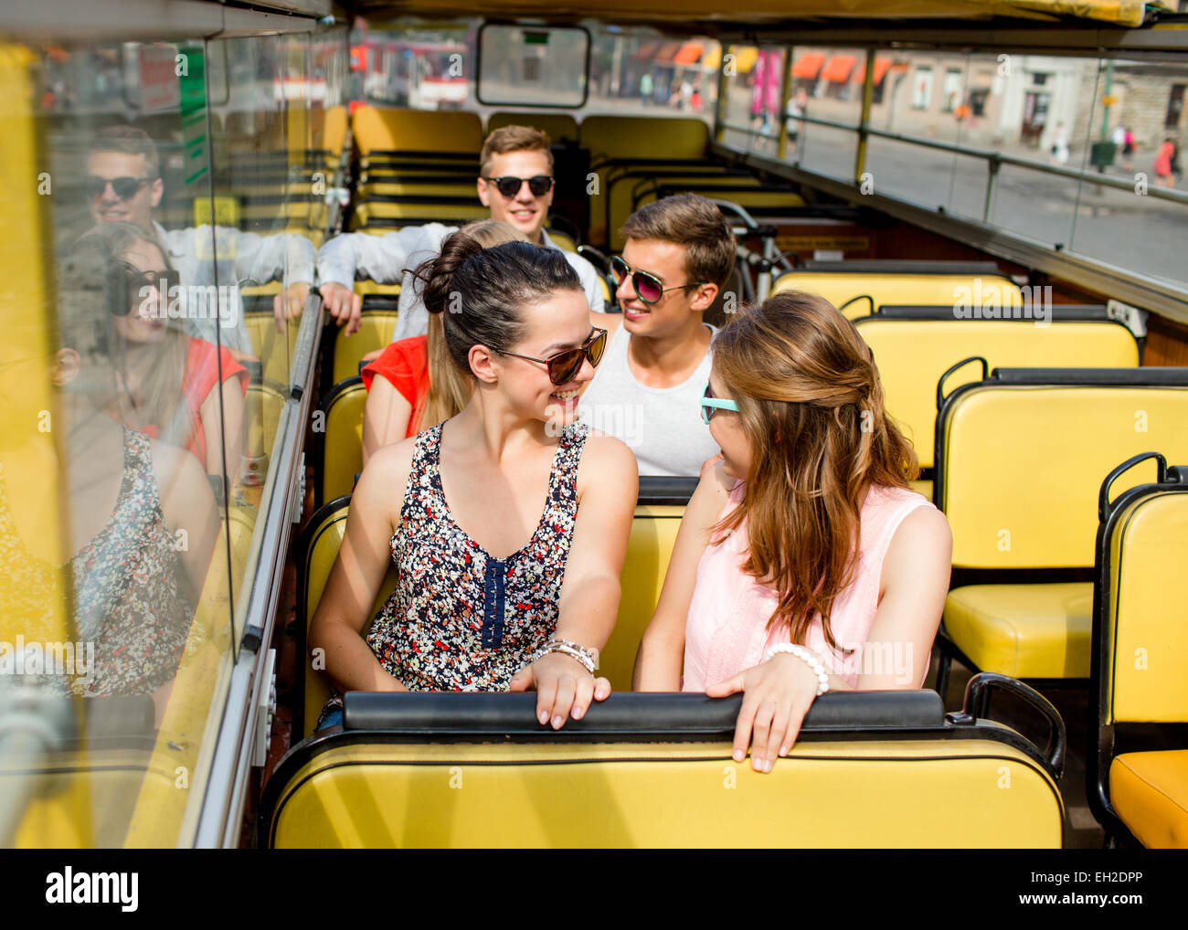group of smiling friends traveling by tour bus Stock Photo - Alamy