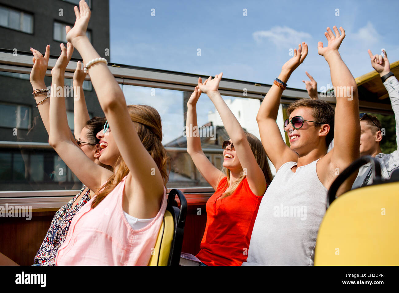 group of smiling friends traveling by tour bus Stock Photo - Alamy