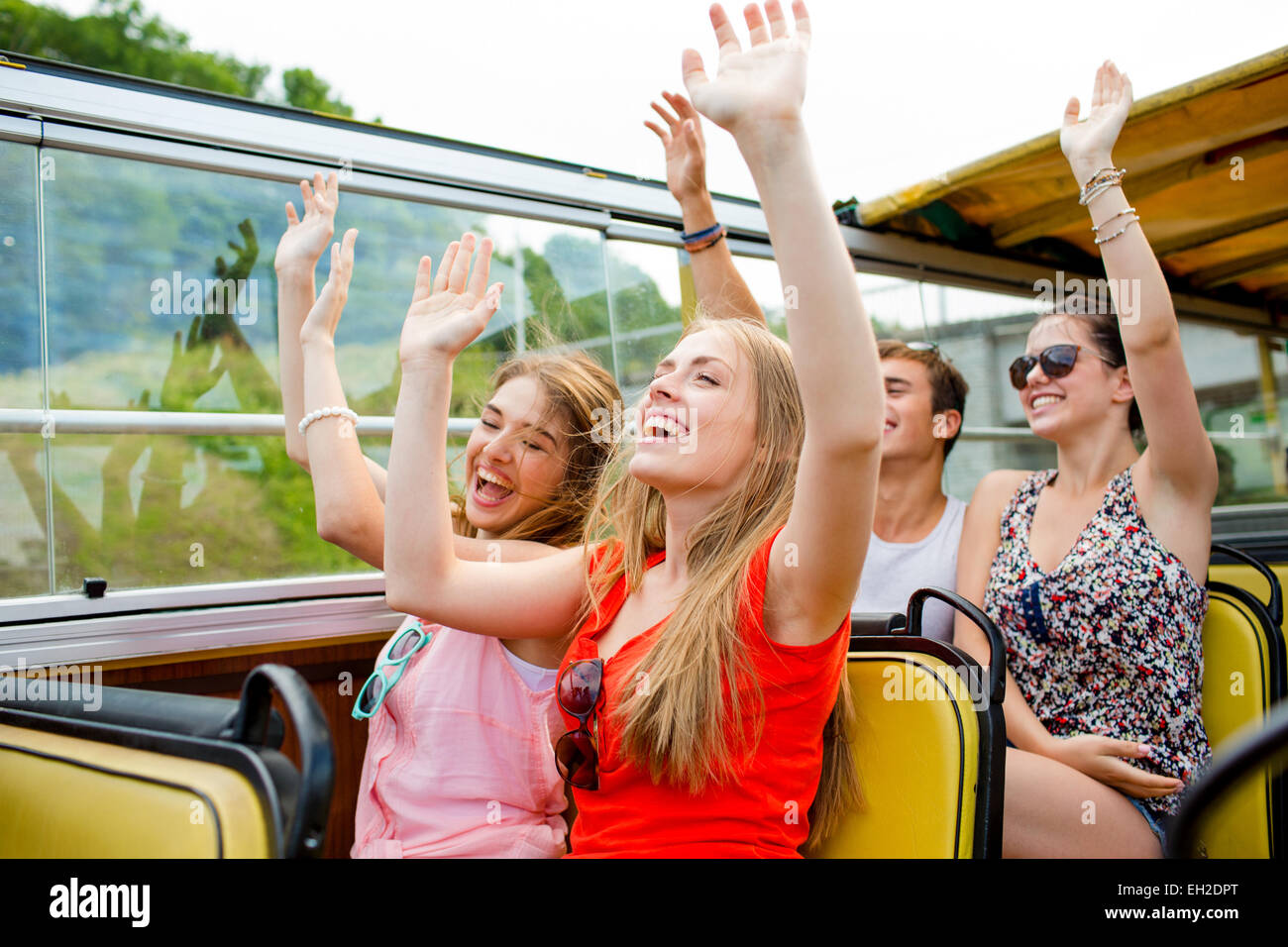 group of smiling friends traveling by tour bus Stock Photo - Alamy