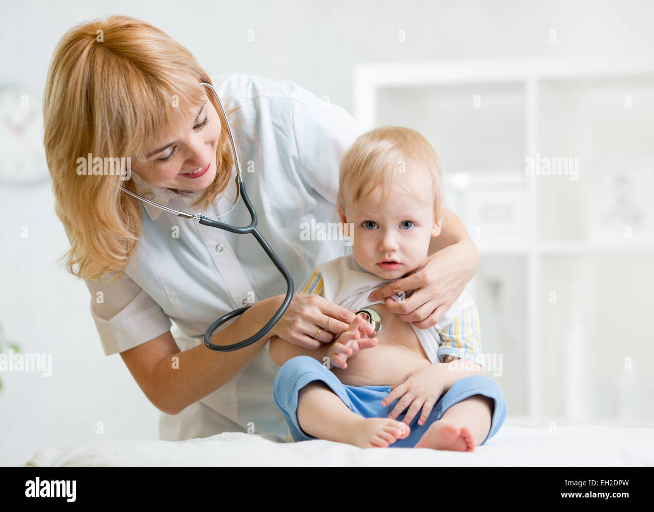 doctor woman examining heartbeat of kid boy with stethoscope Stock ...