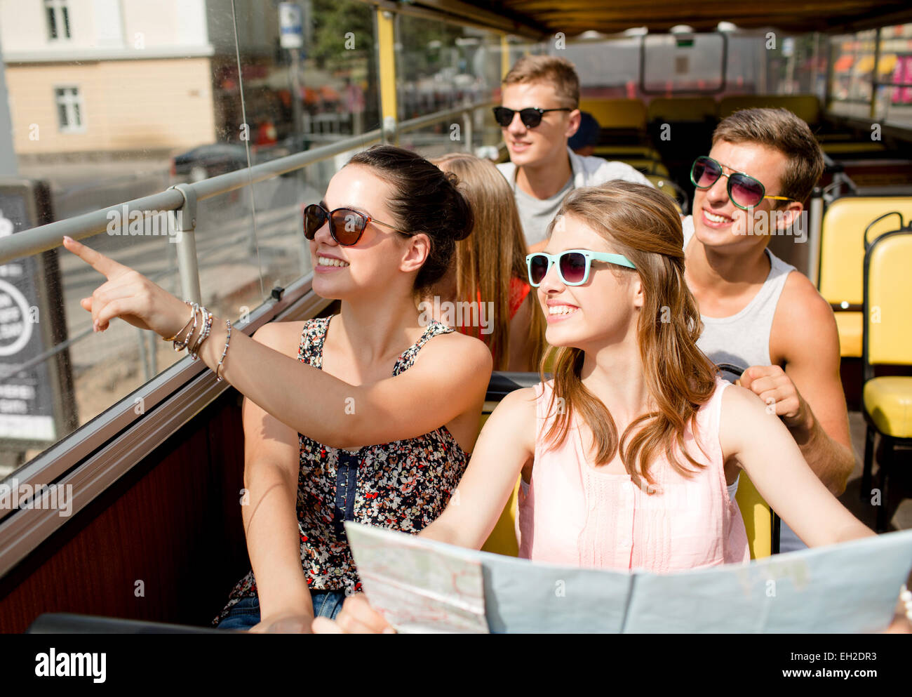 group of smiling friends traveling by tour bus Stock Photo - Alamy
