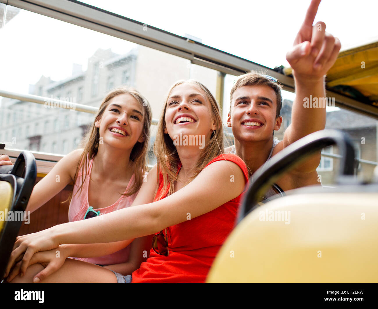 group of smiling friends traveling by tour bus Stock Photo - Alamy
