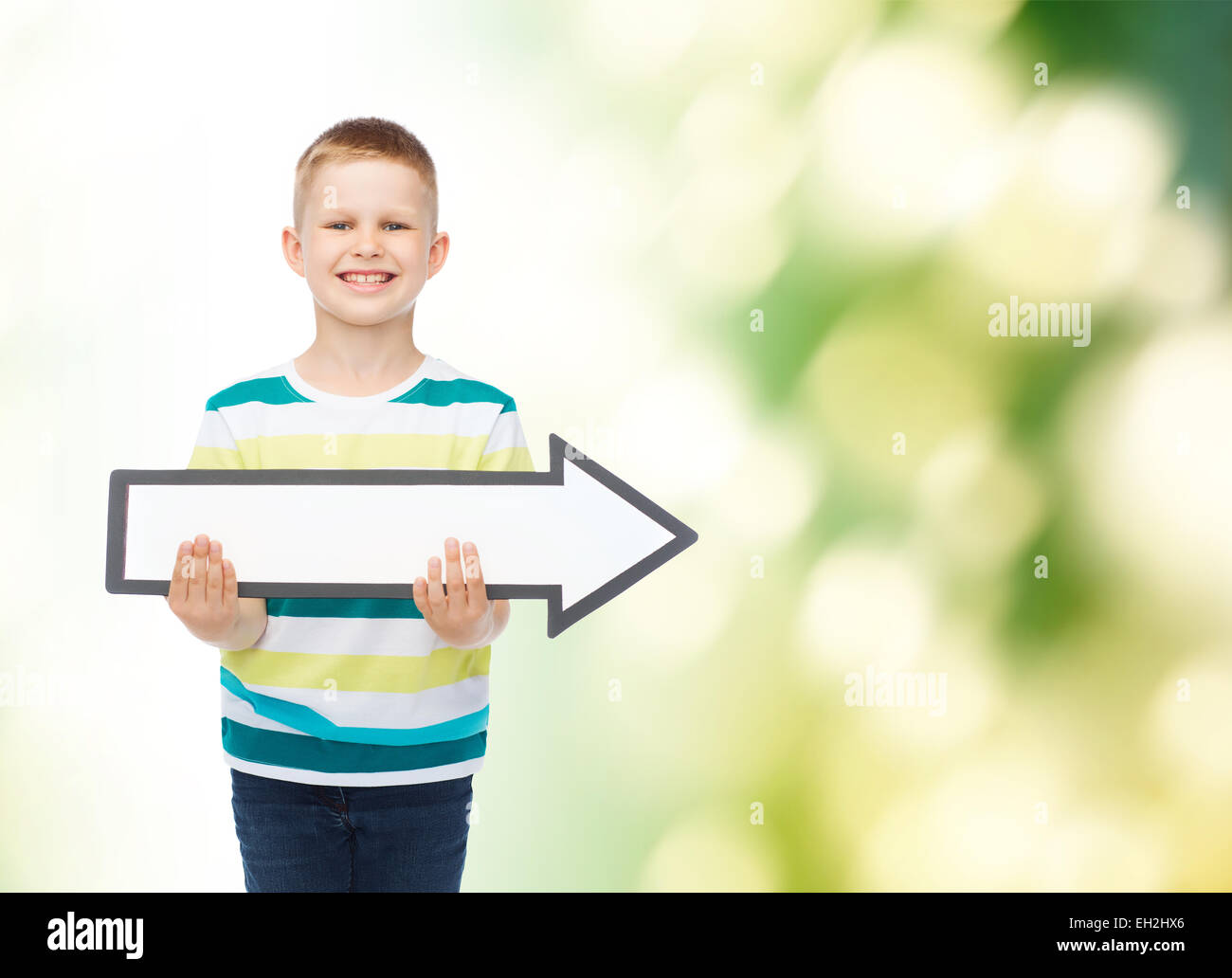 smiling little boy with blank arrow pointing right Stock Photo - Alamy