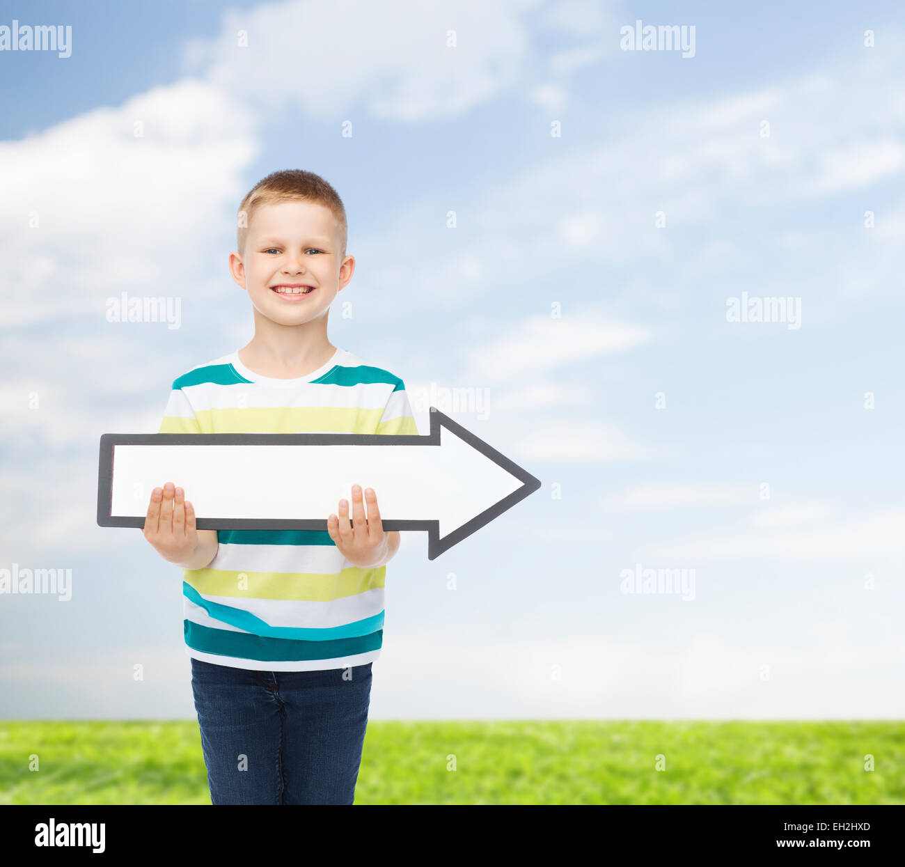 smiling little boy with blank arrow pointing right Stock Photo - Alamy