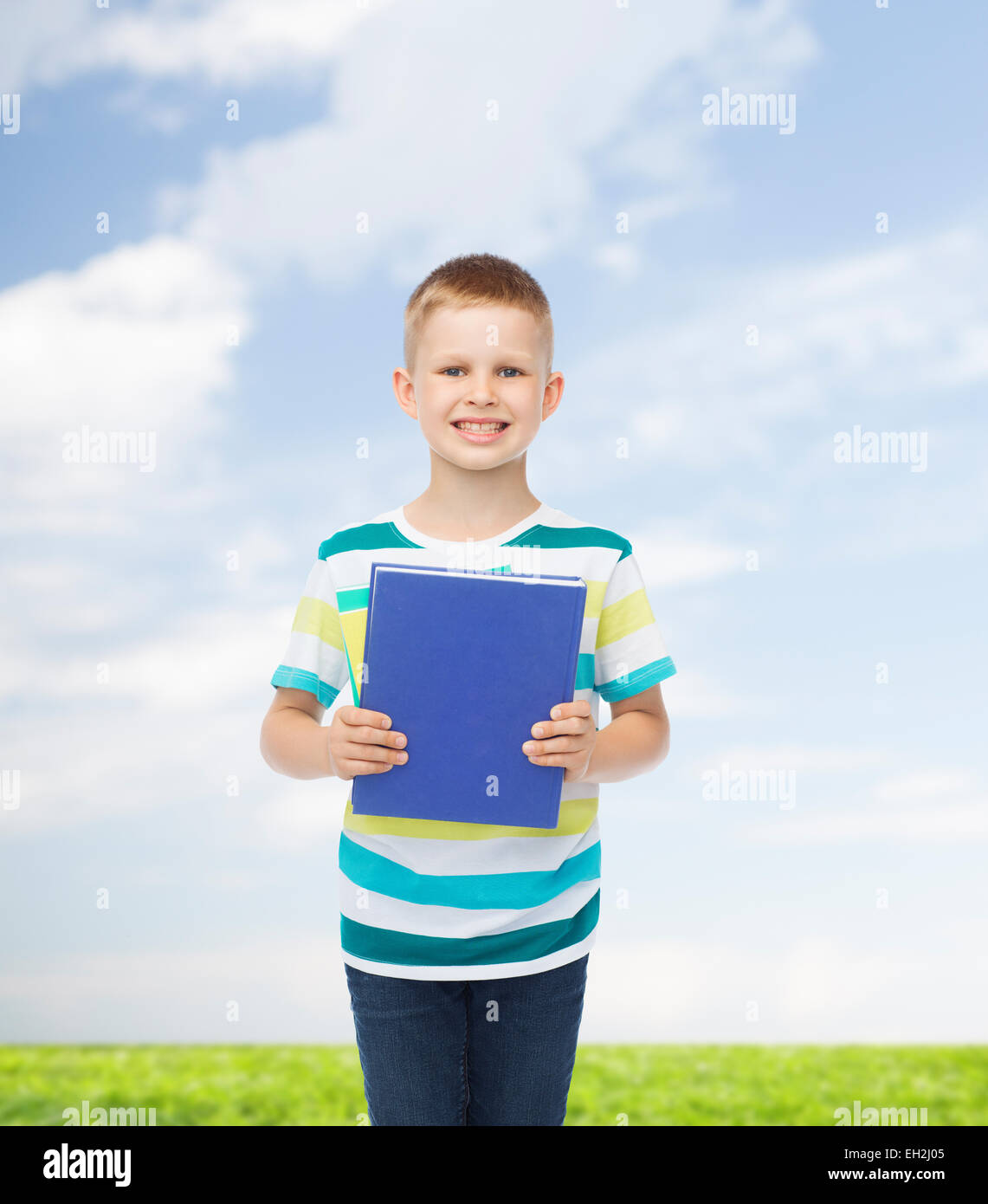 smiling little student boy with blue book Stock Photo - Alamy