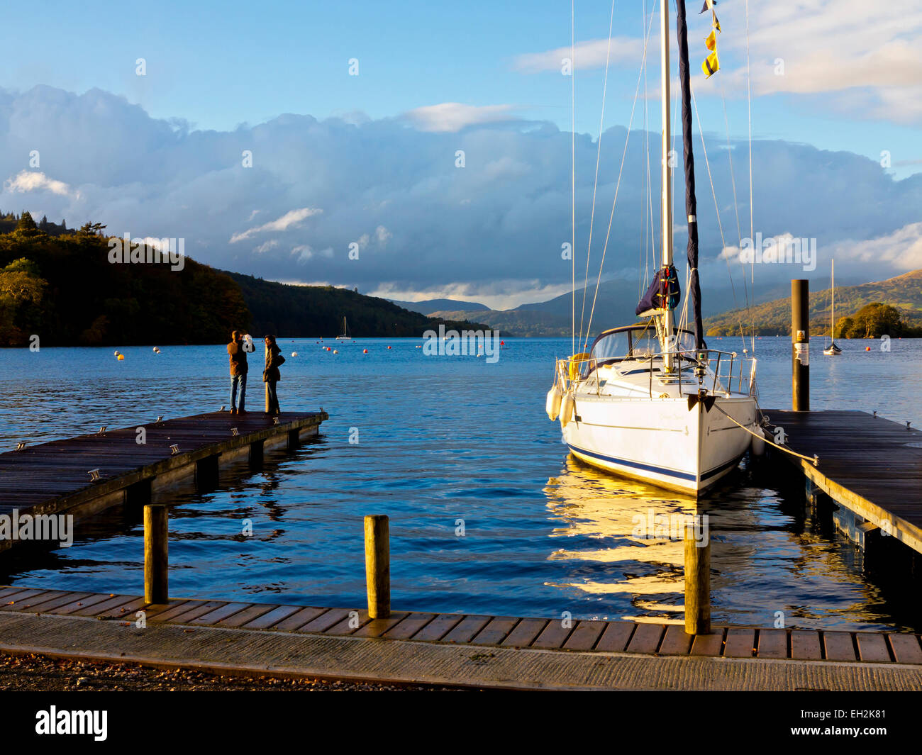Sailing boat moored at a pier on Lake Windermere Lake District National ...