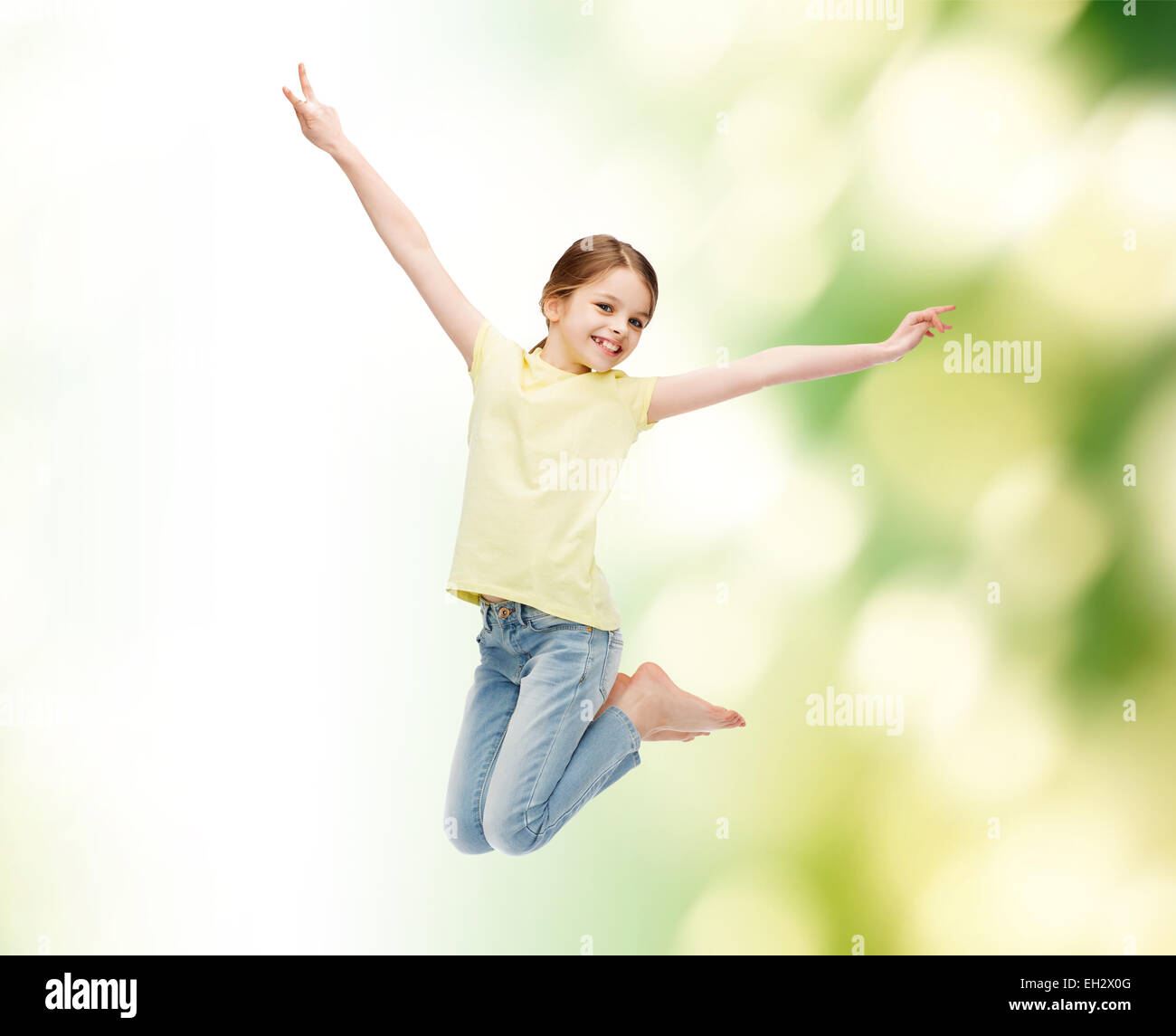 smiling little girl jumping Stock Photo - Alamy