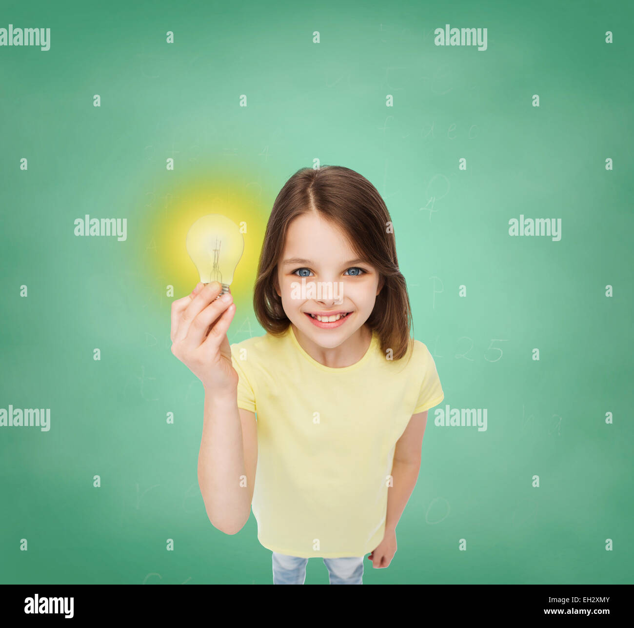 smiling little girl holding light bulb Stock Photo - Alamy
